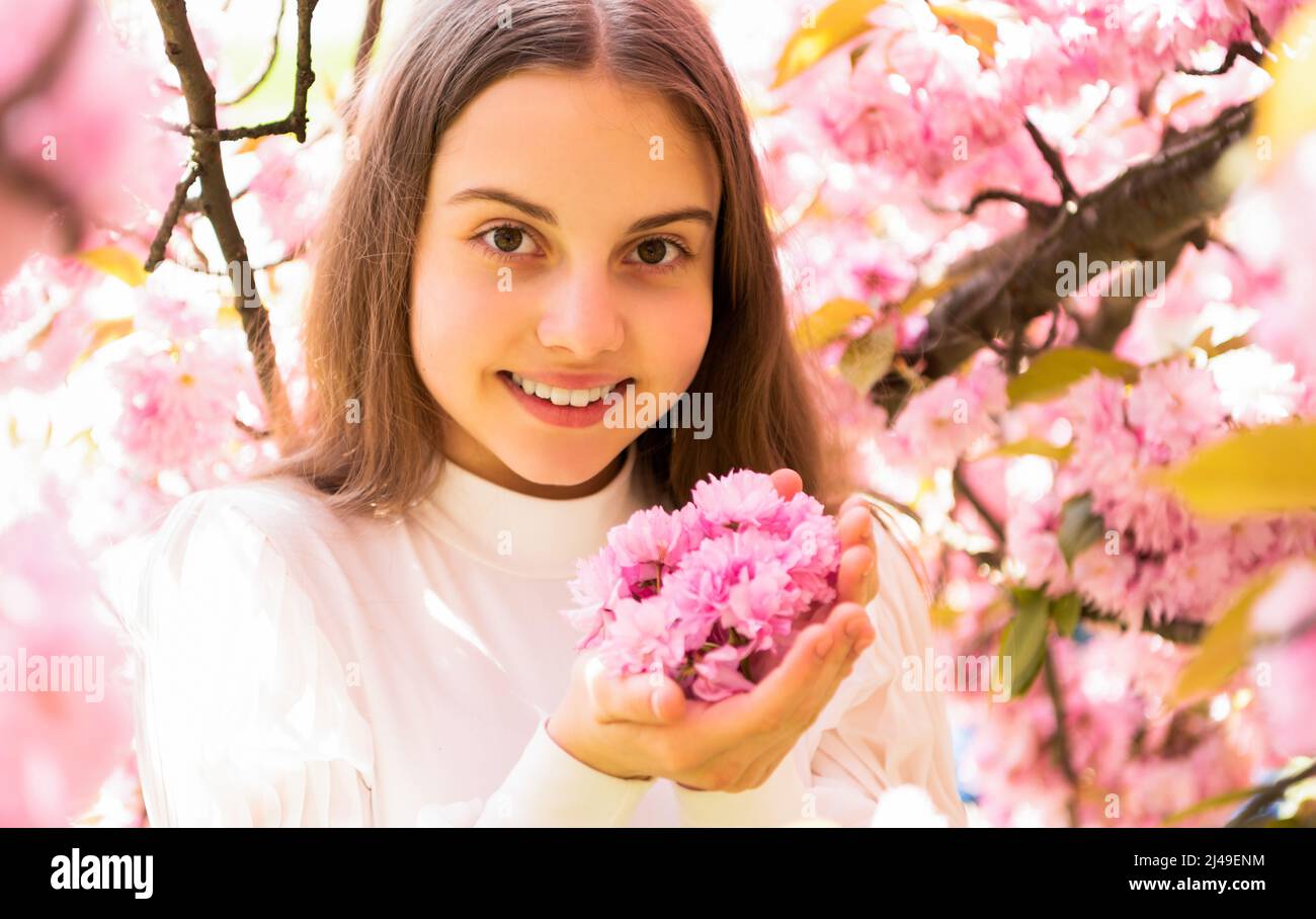 cheerful teen girl at sakura flower bloom in spring Stock Photo - Alamy