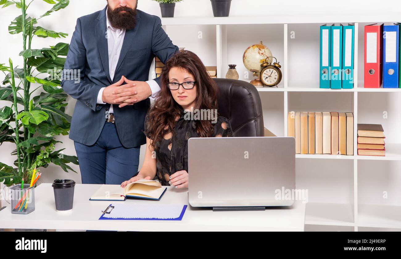 Focusing on the task. Serious woman at work. Man crop view stand over ...
