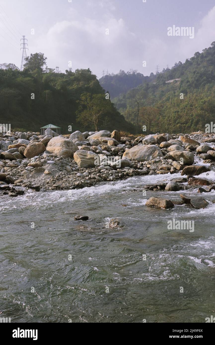 balason river is flowing through the boulders covered terai region at ...