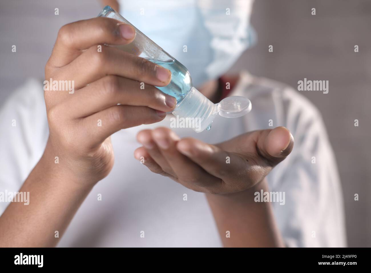 Using sanitizer liquid for preventing corona virus Stock Photo - Alamy
