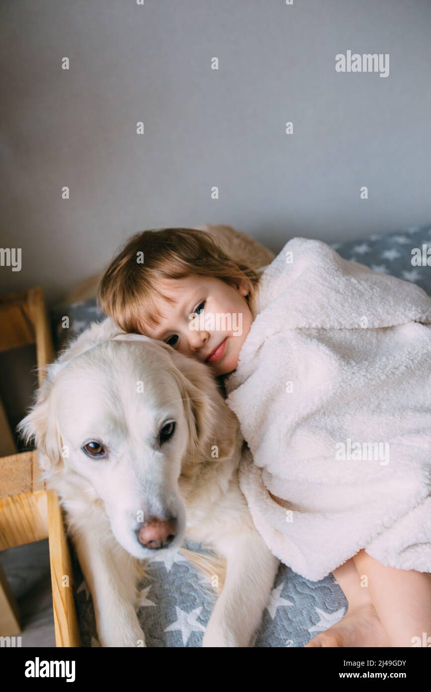 Cute baby and his labrador retriever at home on the bed Stock Photo - Alamy