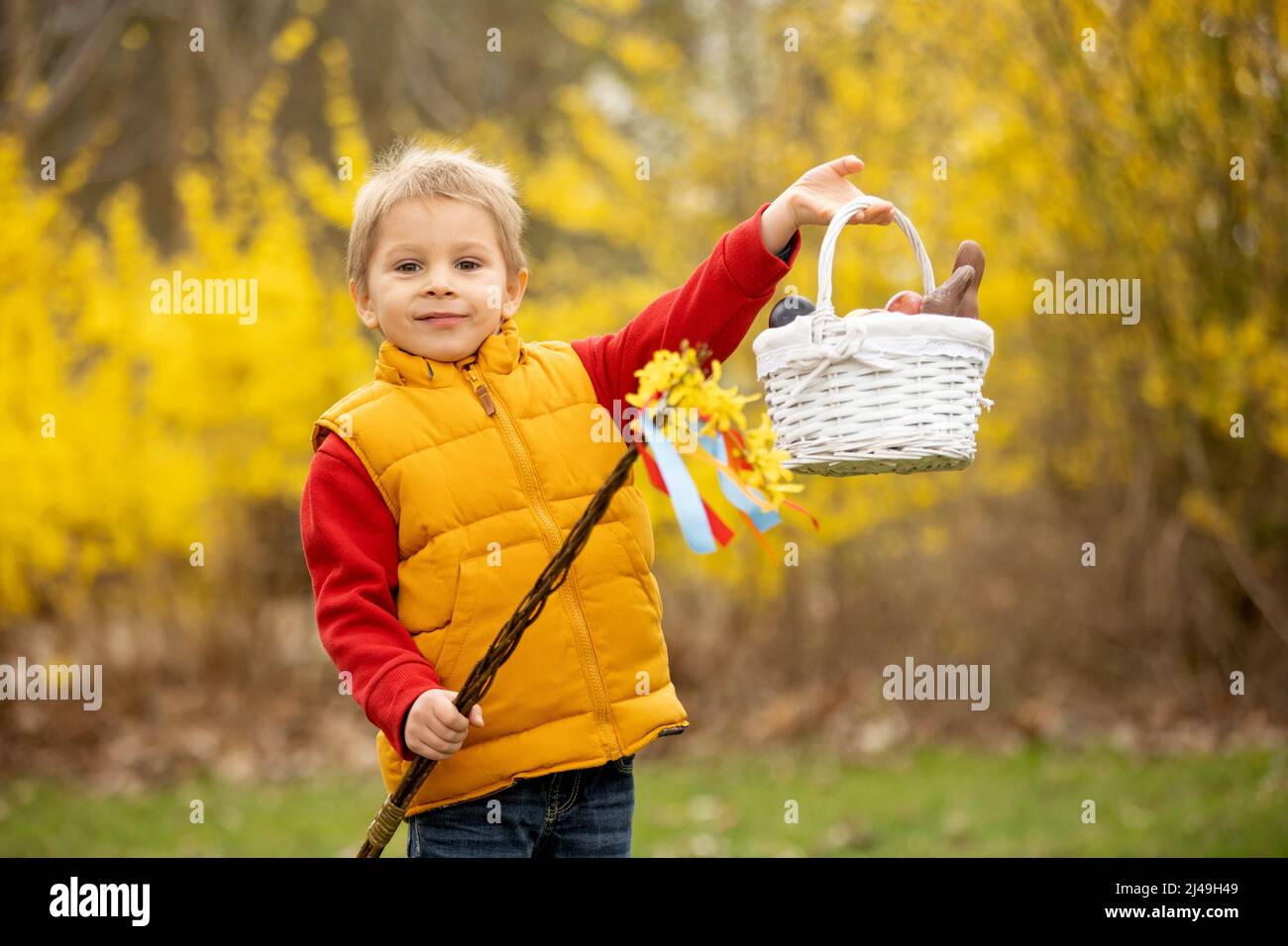 Cute preschool child, boy, holding handmade braided whip made from ...