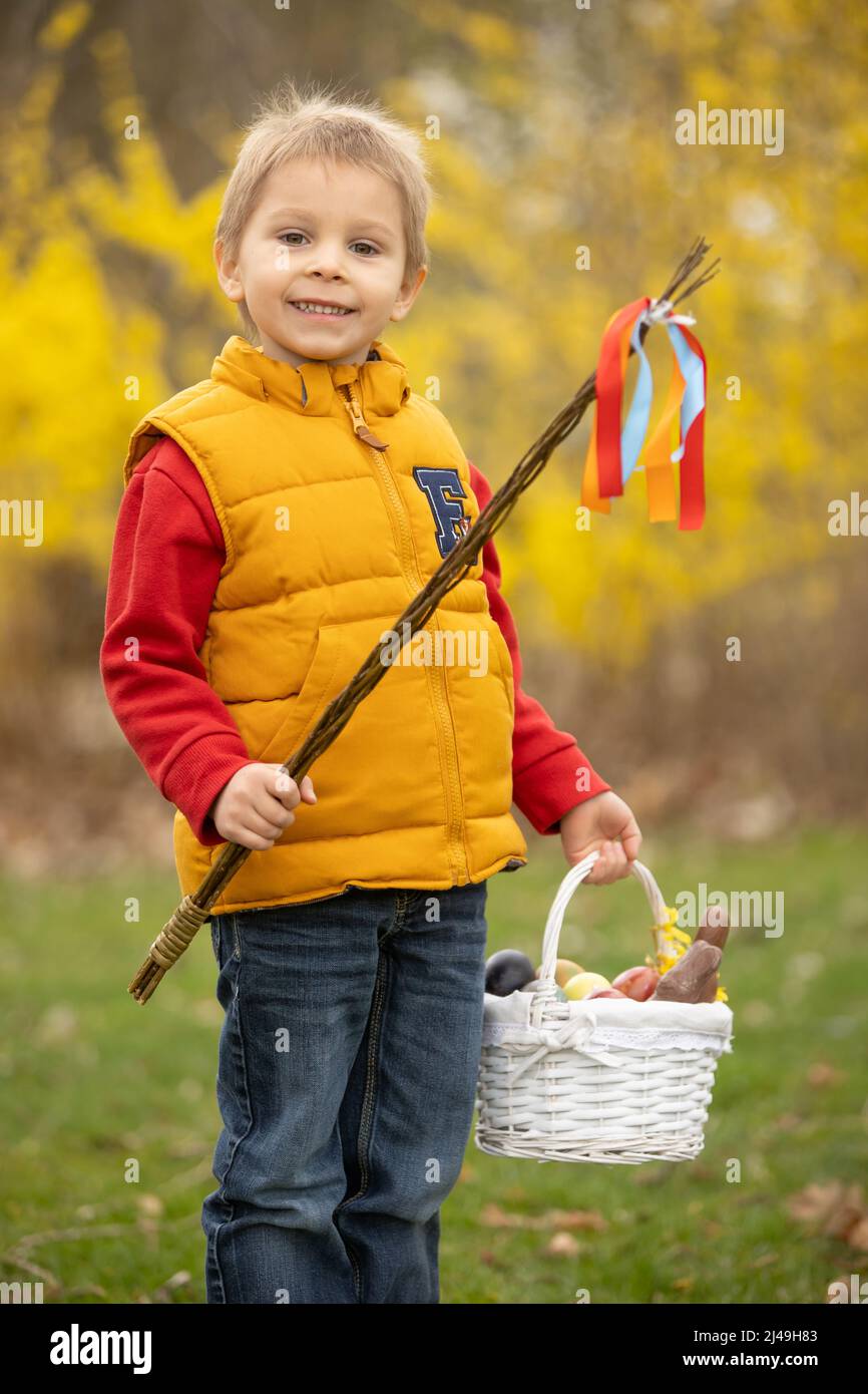 Cute preschool child, boy, holding handmade braided whip made from ...