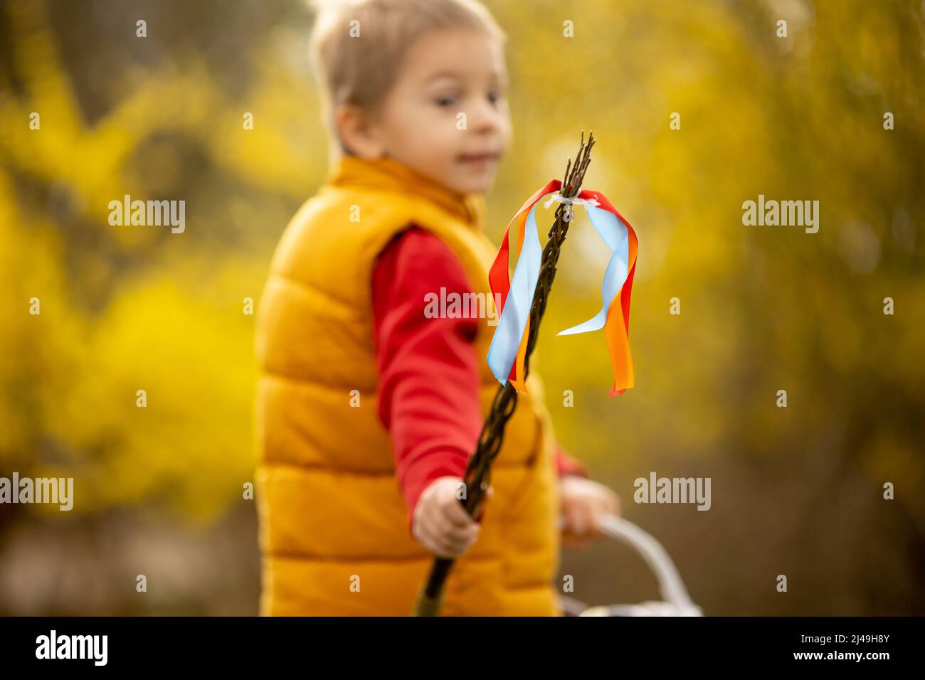 Cute preschool child, boy, holding handmade braided whip made from ...