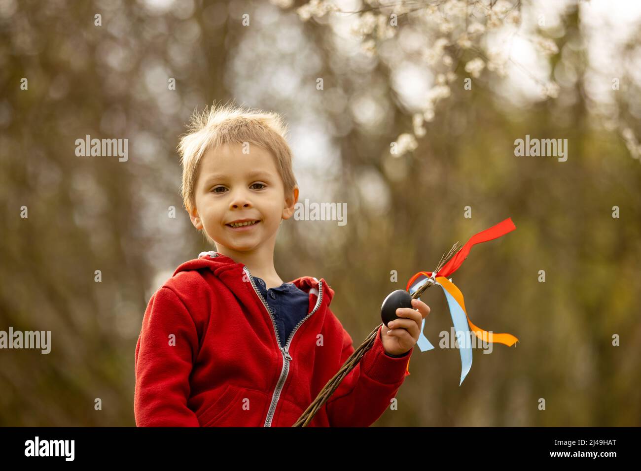 Cute preschool child, boy, holding handmade braided whip made from ...