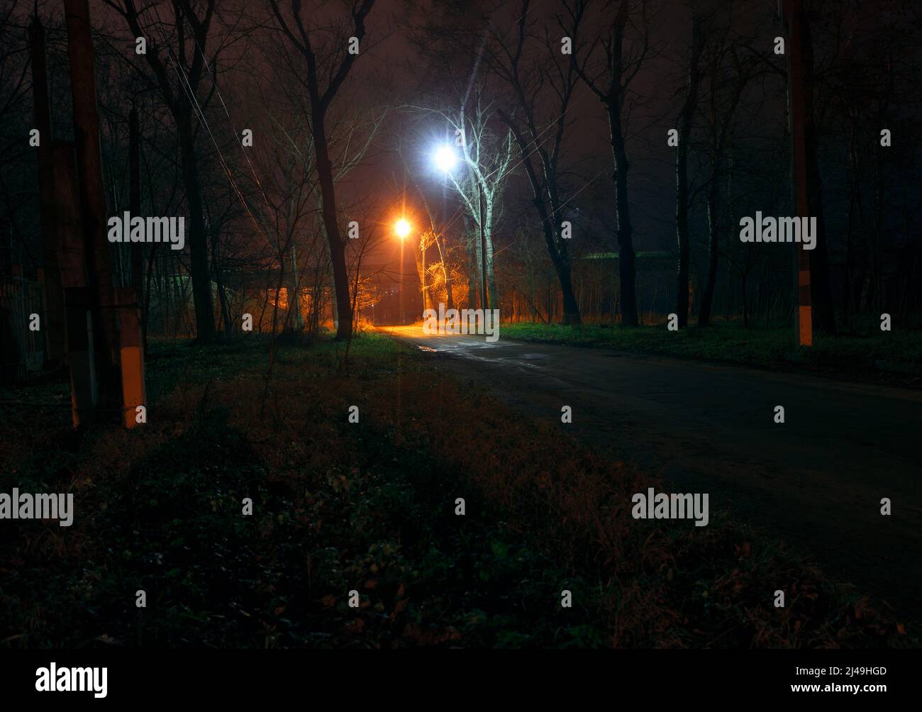 Walkway through a park at night . Illuminated park at nighttime Stock ...