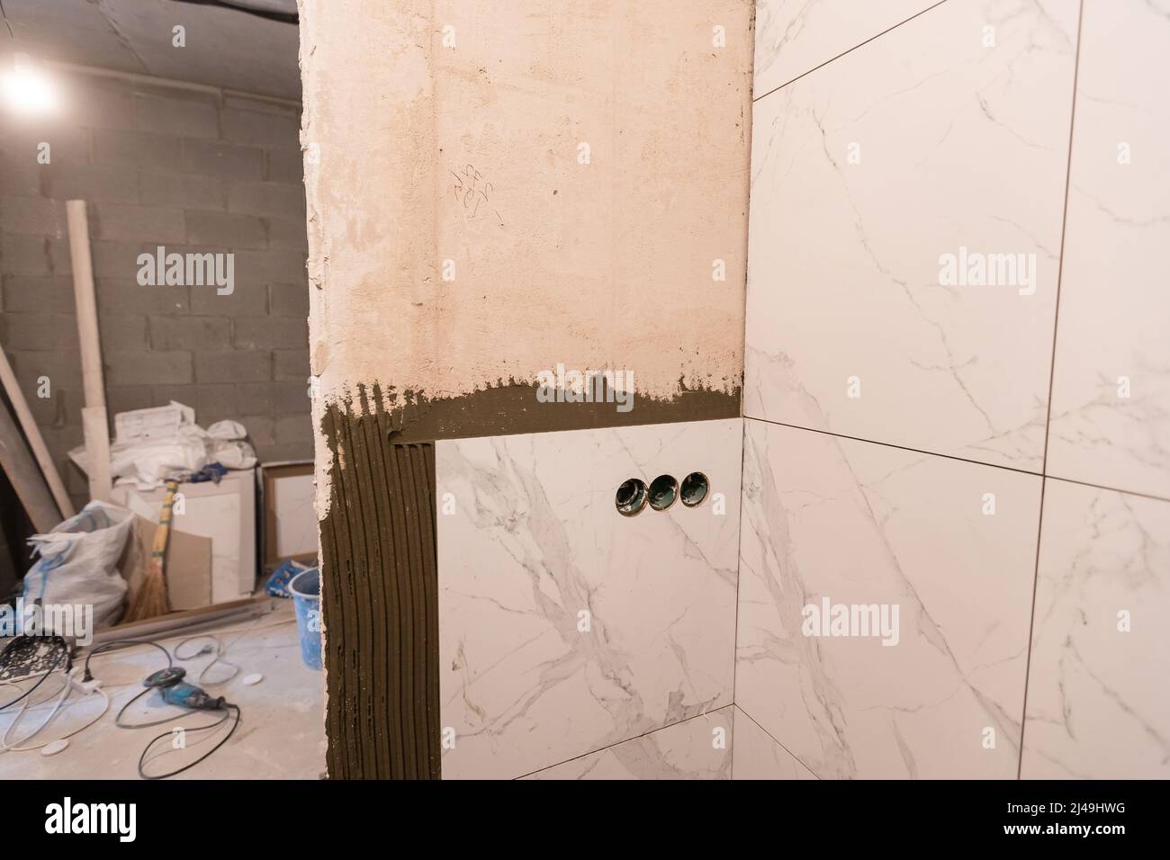 bathroom renovation and tiling. Laying floor ceramic tile Stock Photo ...