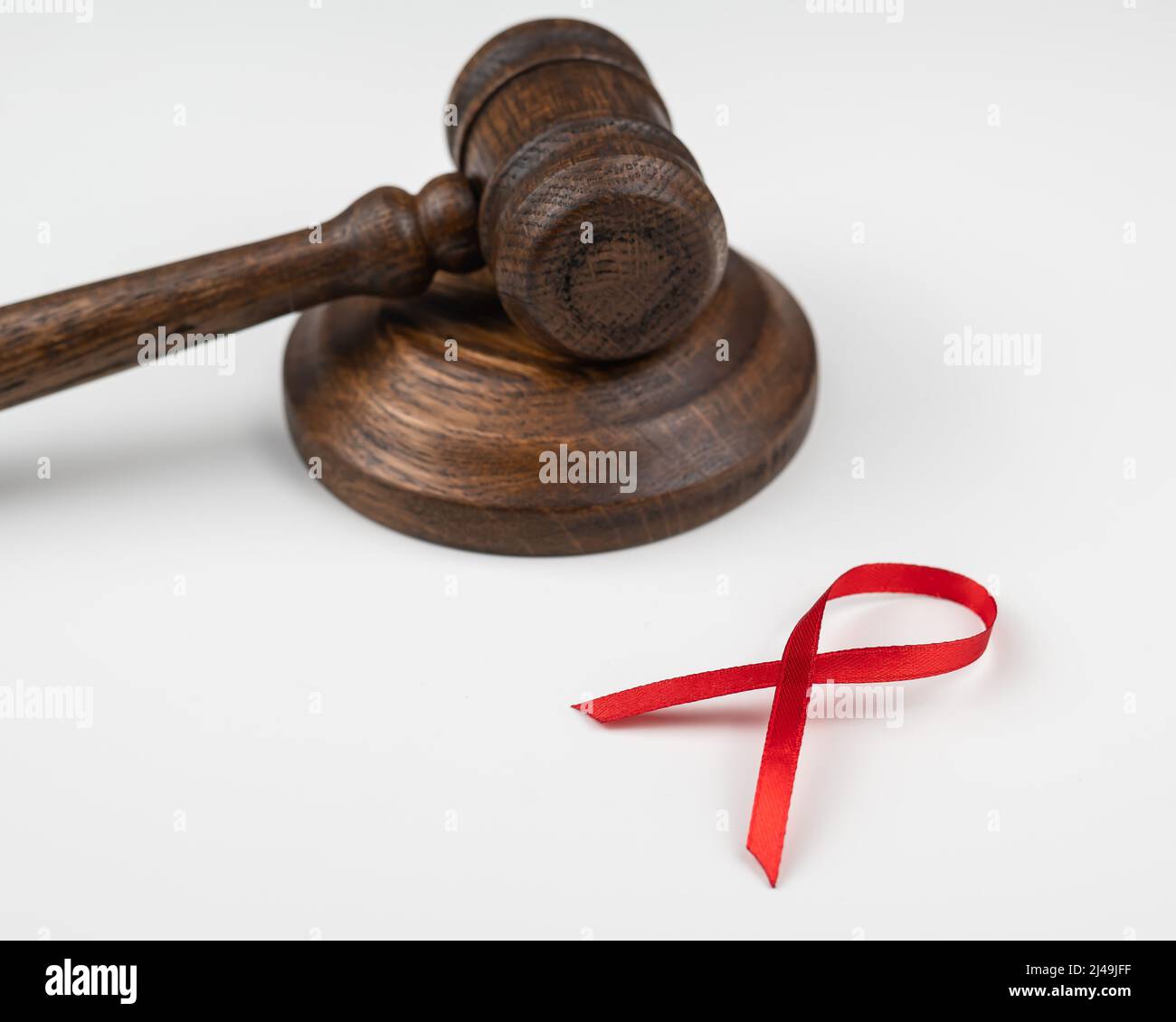 Judicial gavel and red ribbon on a white background. Symbol of the ...