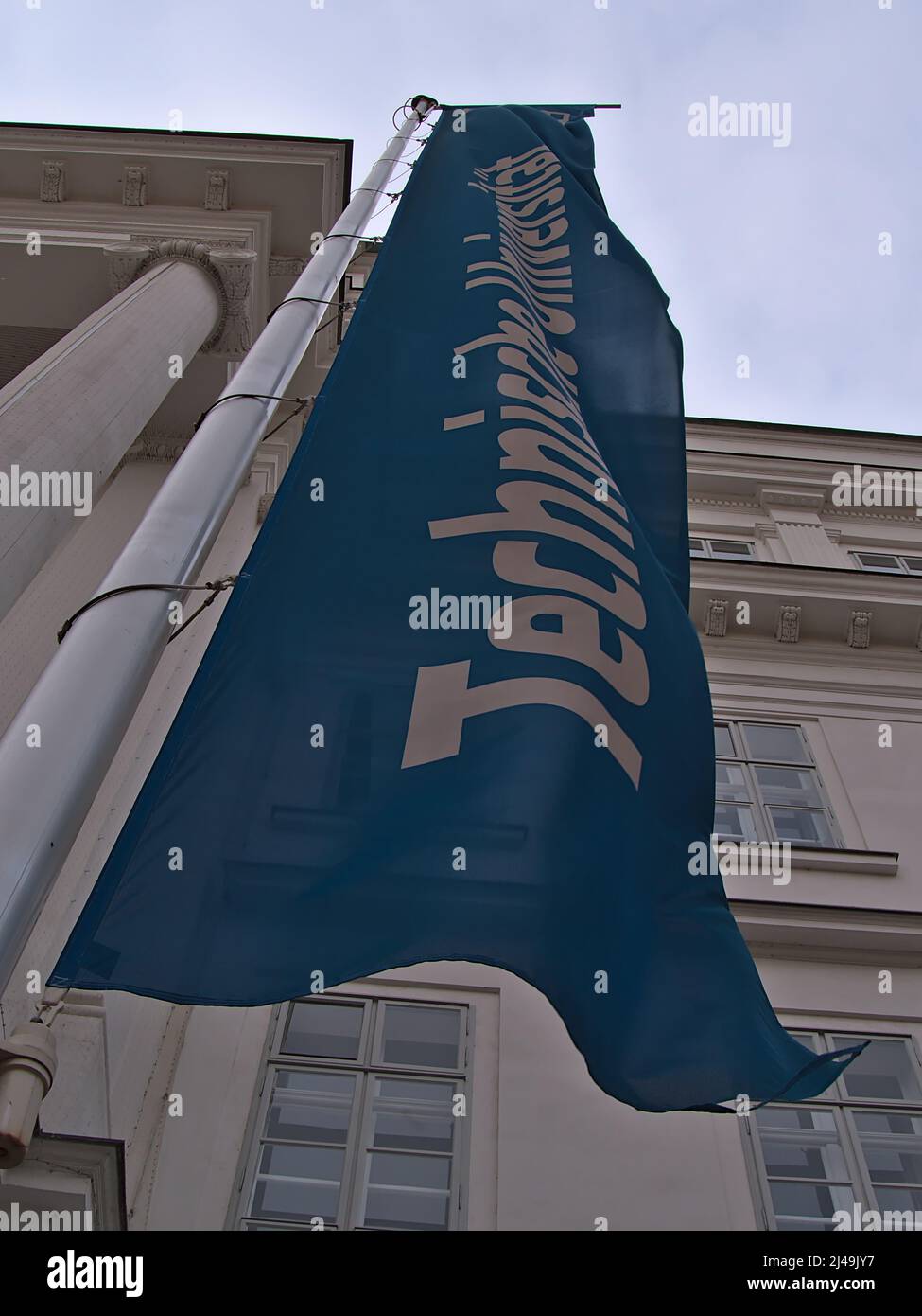 Low angle view of a flag with the blue and white colored lettering of ...