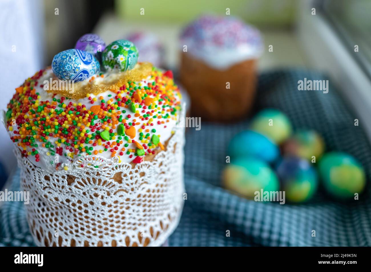 Three traditionally baked orthodox easter cakes with glace icing and ...