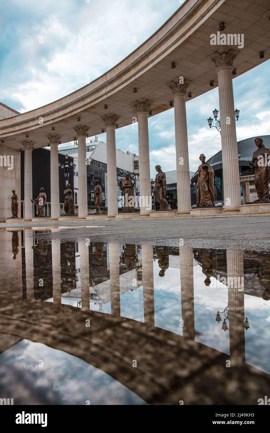 Puddle reflection of many statues just off Mother Teresa Square, Skopje ...