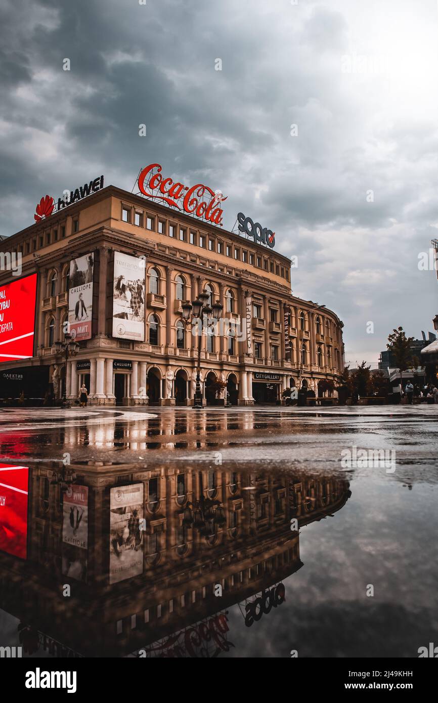Puddle reflection capturing the coca cola logo in Skopje, North ...