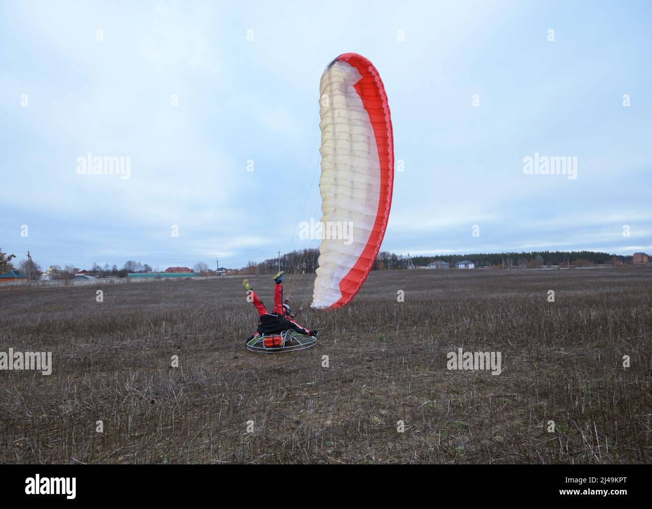 Man paramotorist and paramotor falling down in the field Stock Photo ...