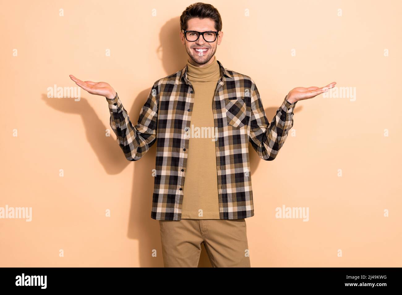 Photo of positive guy promoter hold two hands vs variants options ...