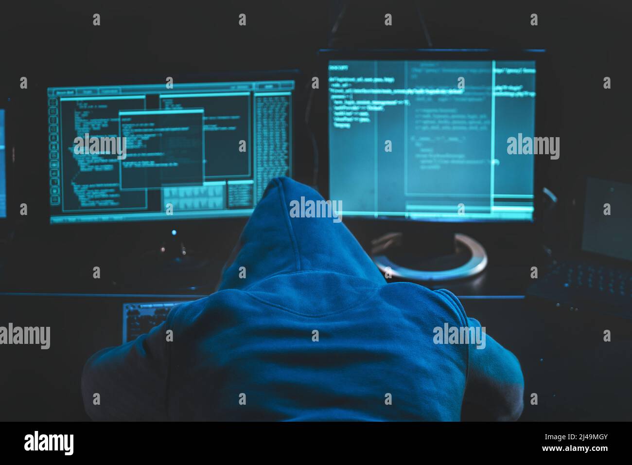 Overworked tired hacker. hooded hacker sleeping at his computer ...