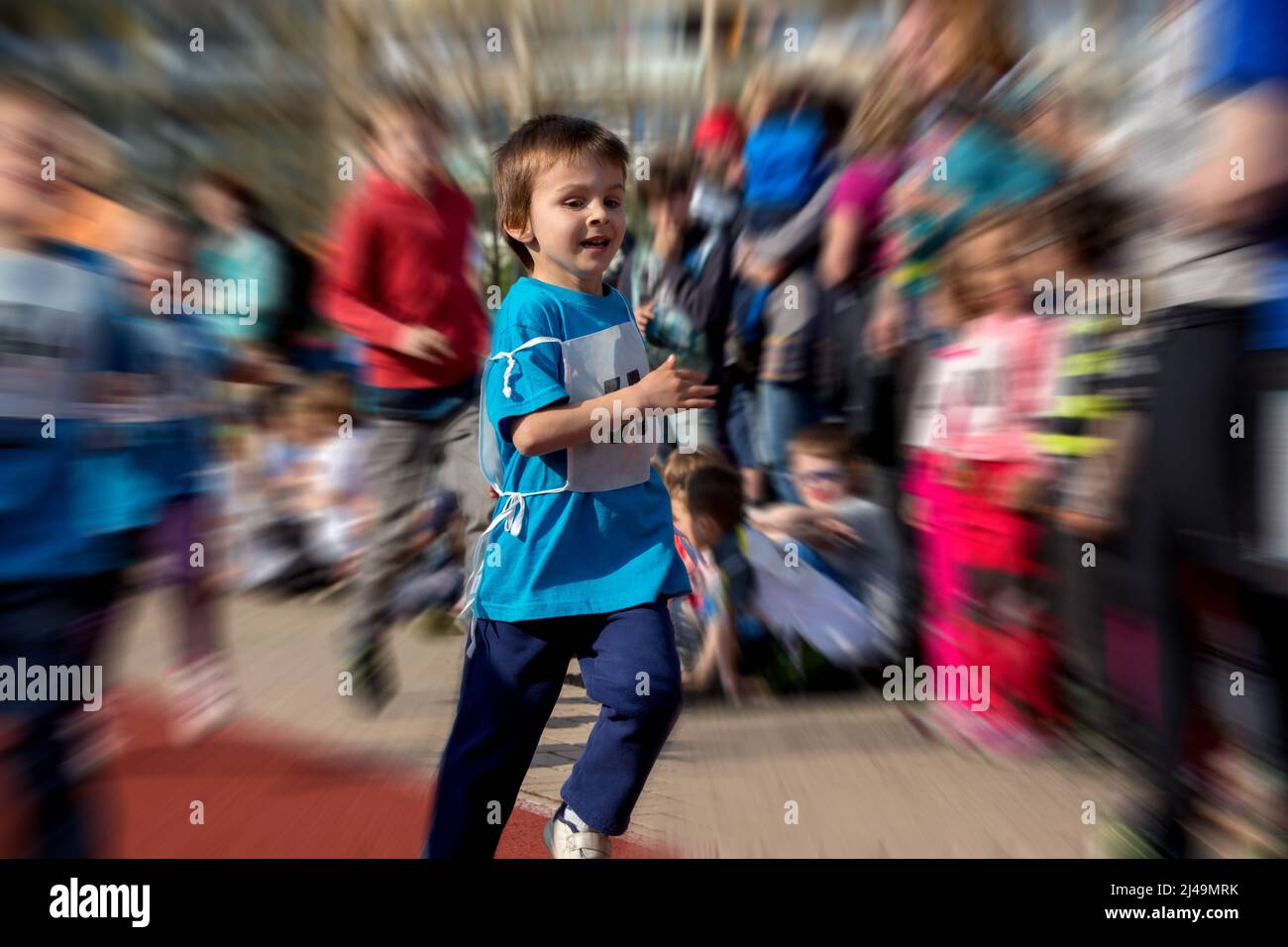 Young preschool children, running on track in a marathon competition ...