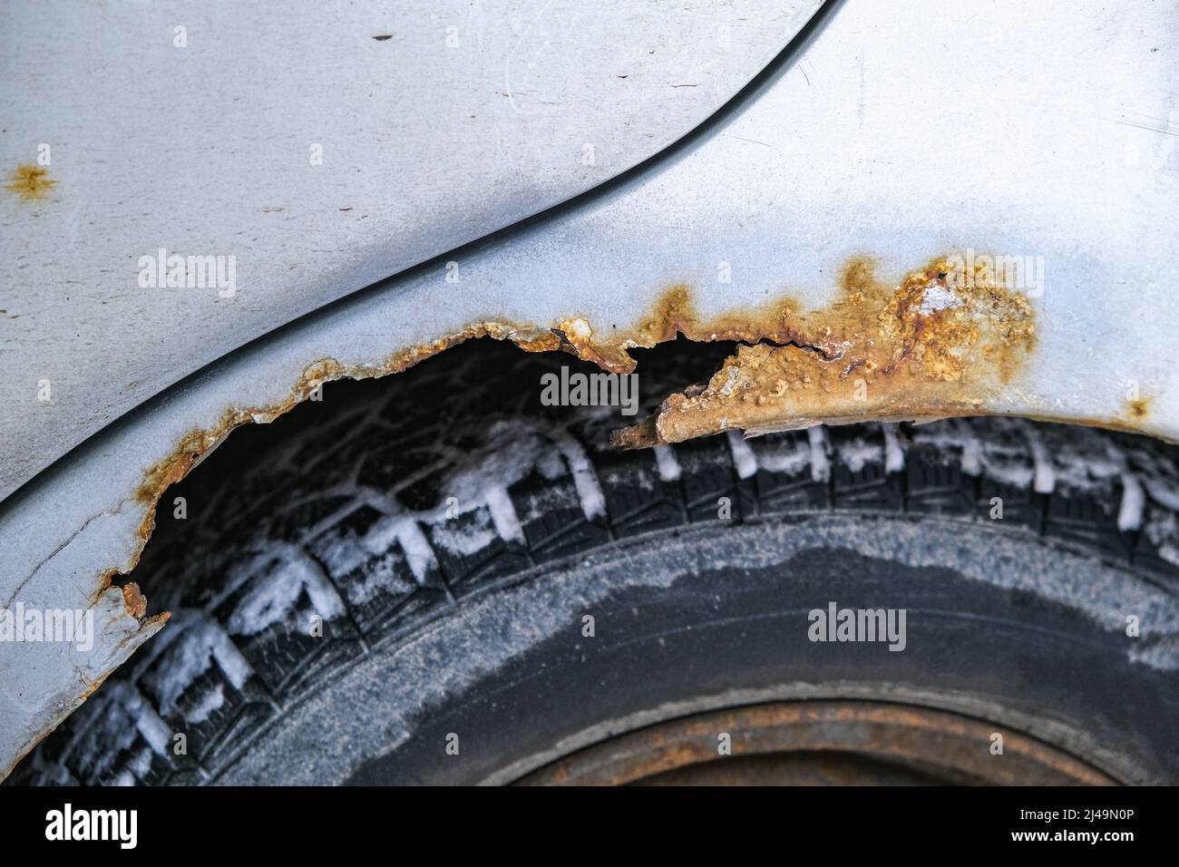 Rust on the door and fender of the car. Consequences of salt, snow ...