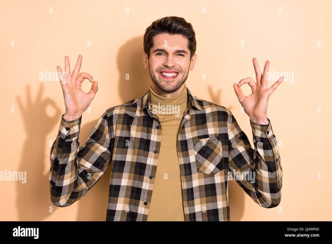 Photo of positive guy promoter make double okay symbols demonstrate ...