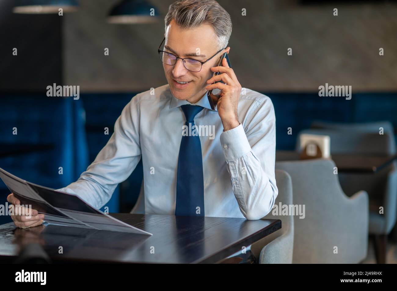 Good-looking businessman sitting in a cafe Stock Photo - Alamy