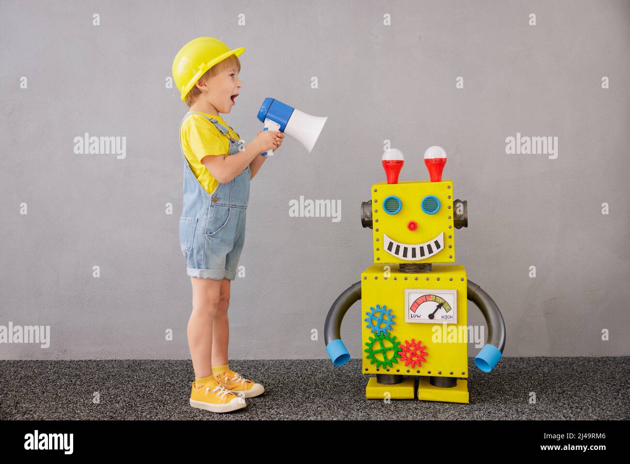 Happy child with robot. Funny kid playing at home. Boy shouting over ...
