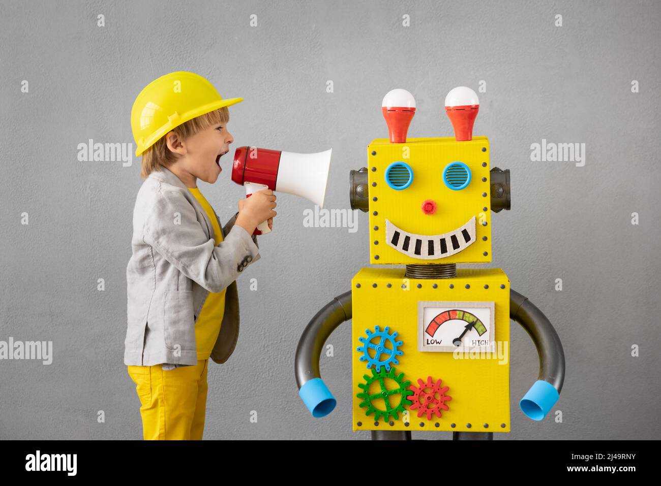 Happy child with robot. Funny kid playing at home. Boy shouting over ...