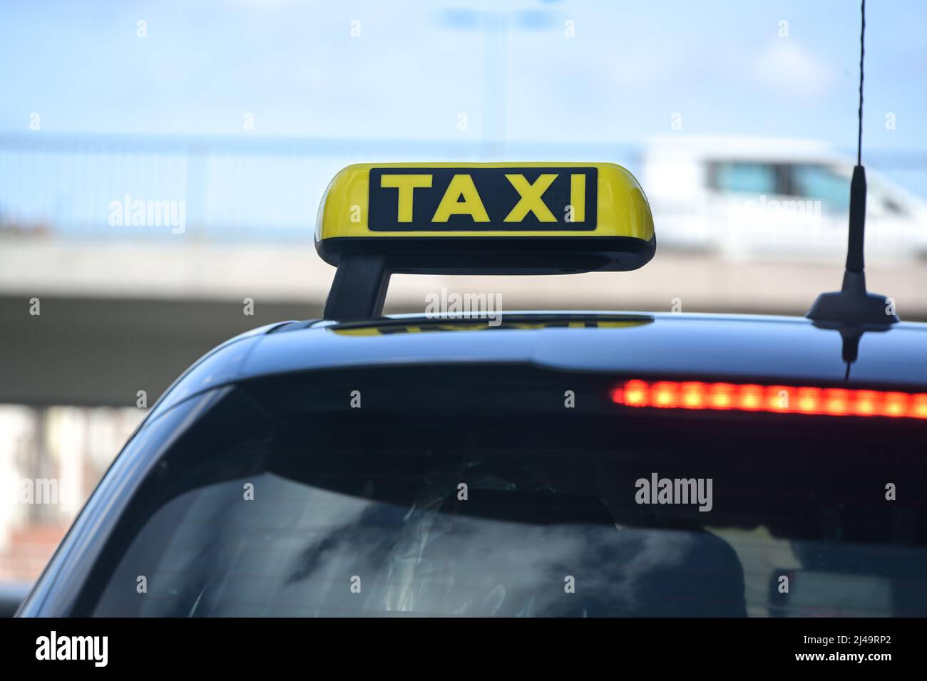 Yellow taxi sign on a black car in the city, detail of the vehicle for ...