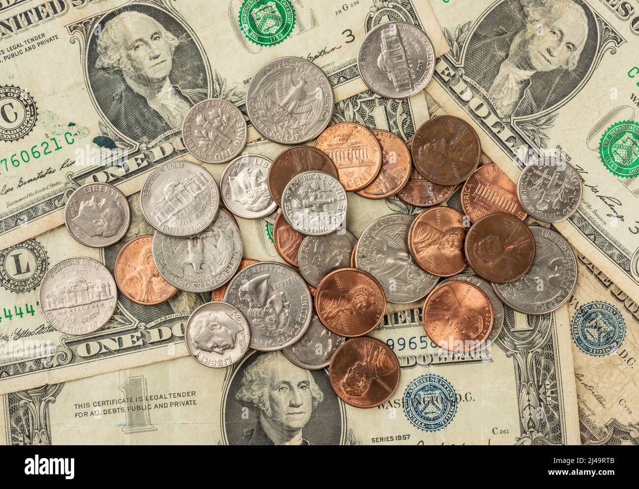 One dollar bills and cents coins spread Stock Photo - Alamy