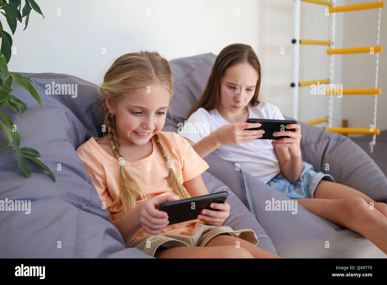 Children play with a mobile phone at home Stock Photo - Alamy