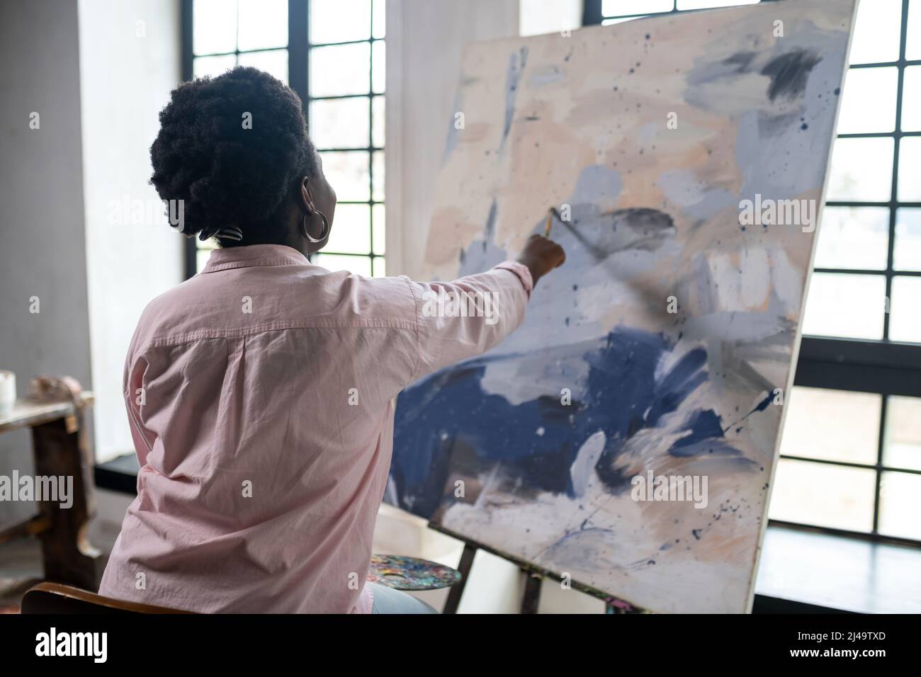 African american artist painting easel hi-res stock photography and ...
