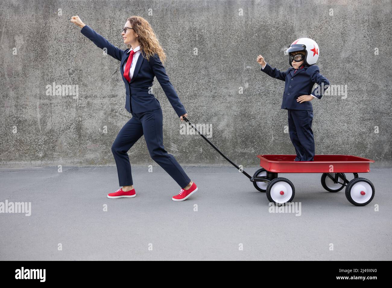 Happy woman going to work. Funny child riding retro wagon. Happy family ...