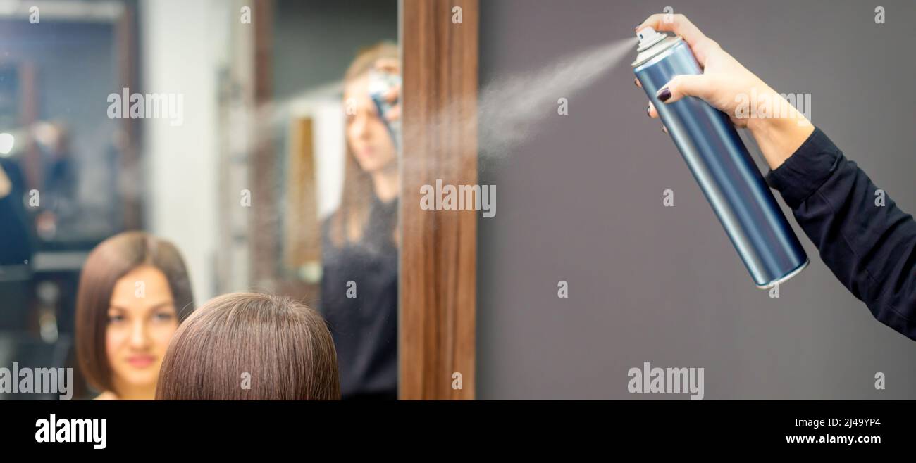 Barber using hair spray fixating hi-res stock photography and images ...