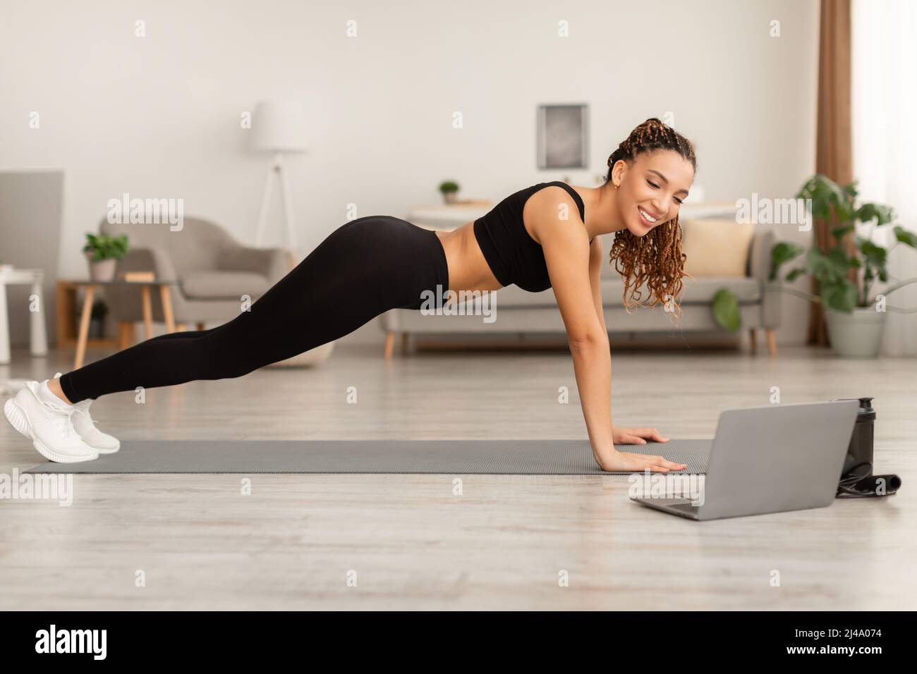 African Lady Near Laptop Standing In Plank Exercising At Home Stock ...