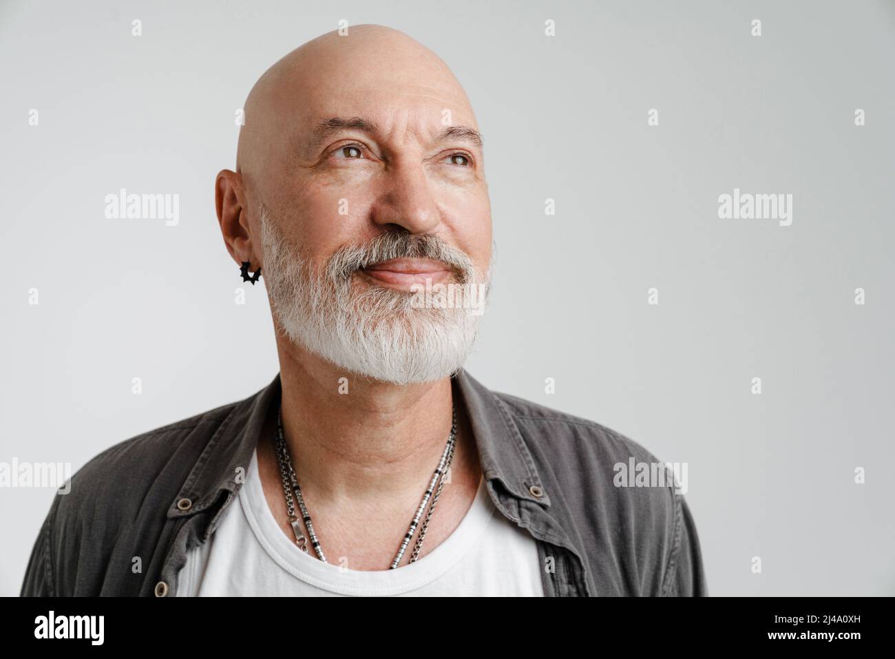 Bald european man with beard posing and looking aside isolated over ...