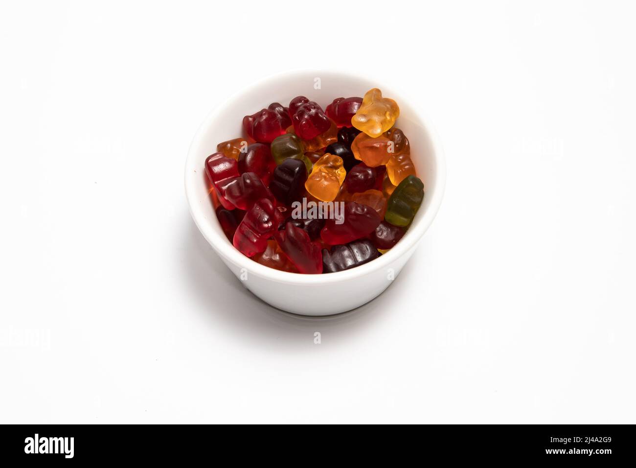 Colorful gummy candies in a white cup on white background Stock Photo ...