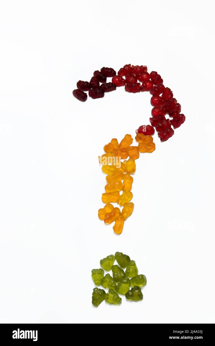 A question mark made of colorful gummy candies on white background ...