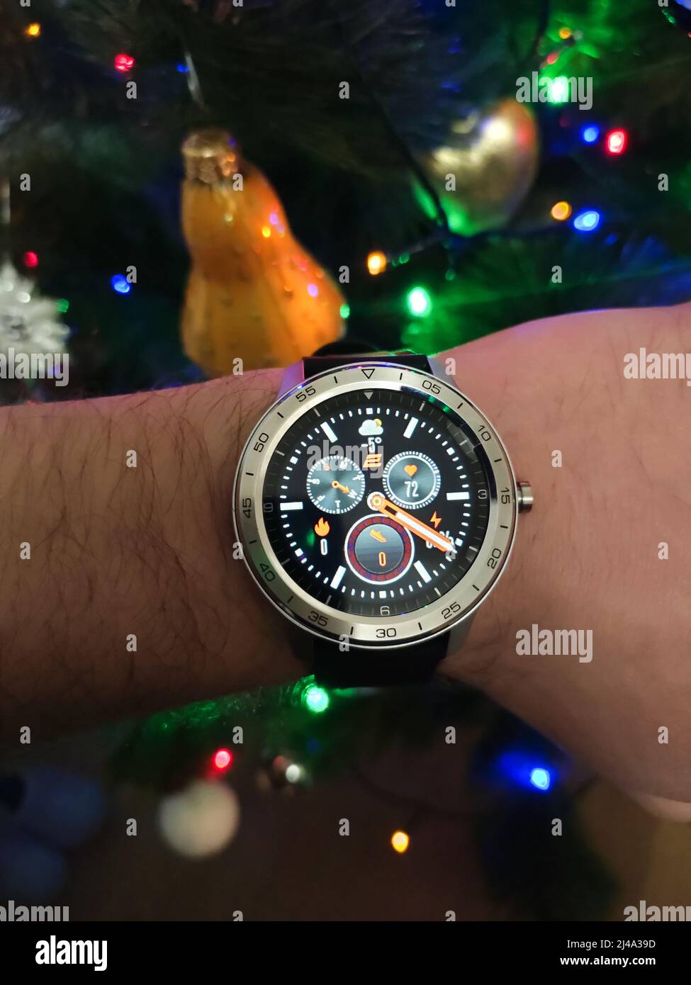 a round men's smart watch on a man's hand Stock Photo - Alamy