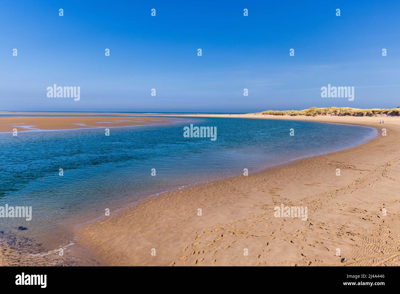 Budle Water flowing towards the sea at Budle Point, Northumberland ...