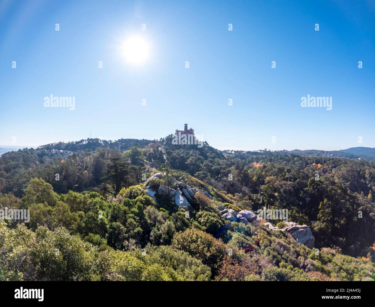The Pena Palace, national monument on the top of a green hill in the ...