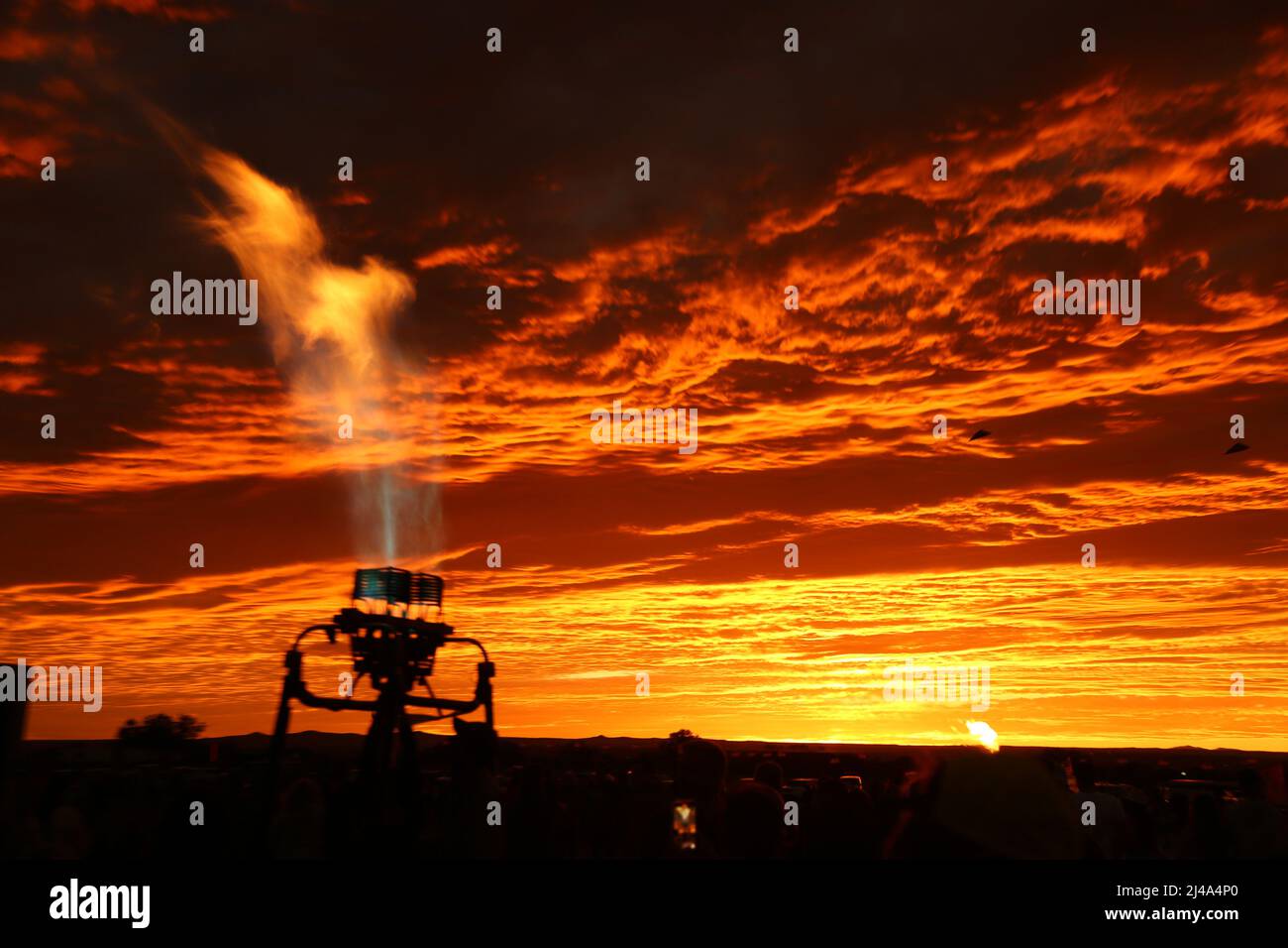 Windy Balloon Fiesta Sunset, hot air balloon with red sunset sky over ...