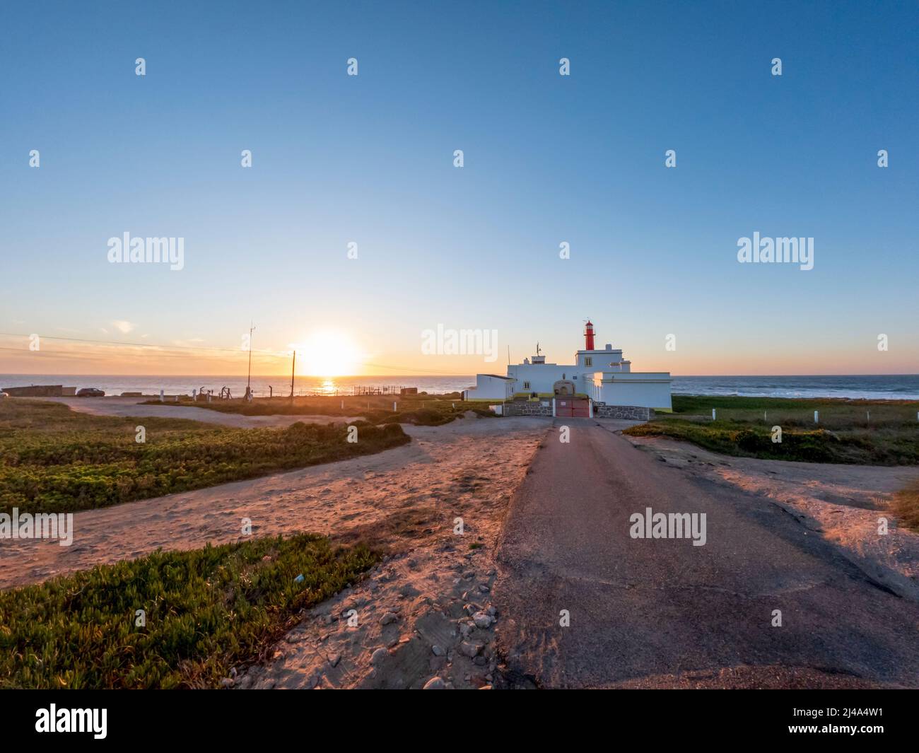 Cabo Raso Lighthouse at sunset golden light, an active Portuguese ...