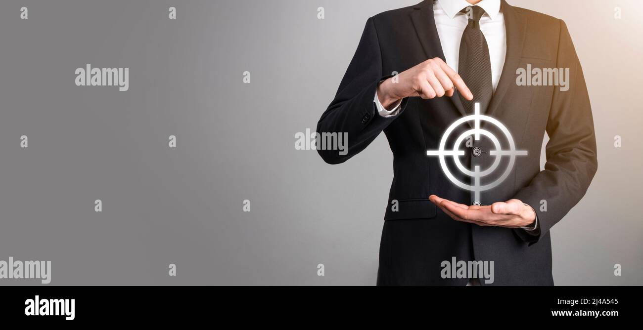 Targeting concept with businessman hand holding target icon dartboard ...