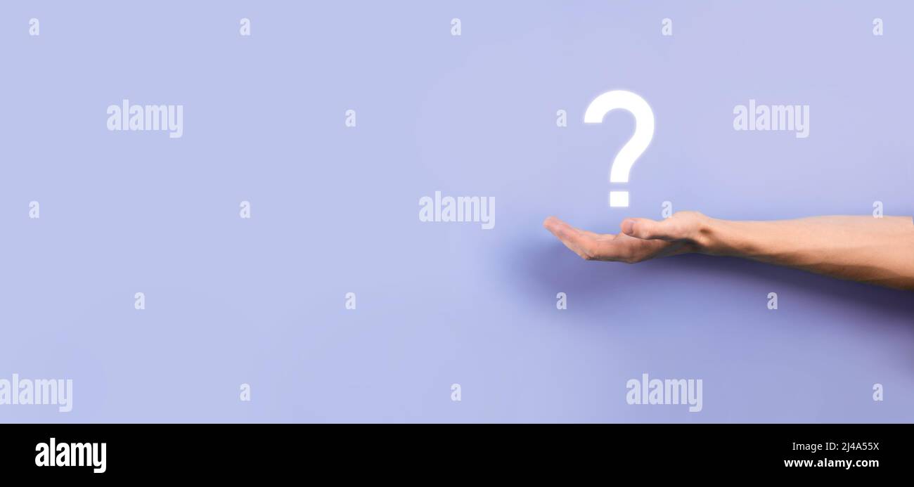 Male hand holding question mark icon on dark background.Banner with ...