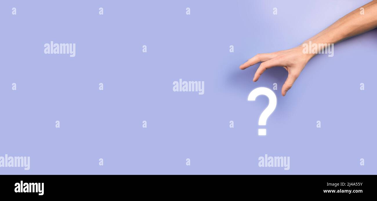 Male hand holding question mark icon on dark background.Banner with ...