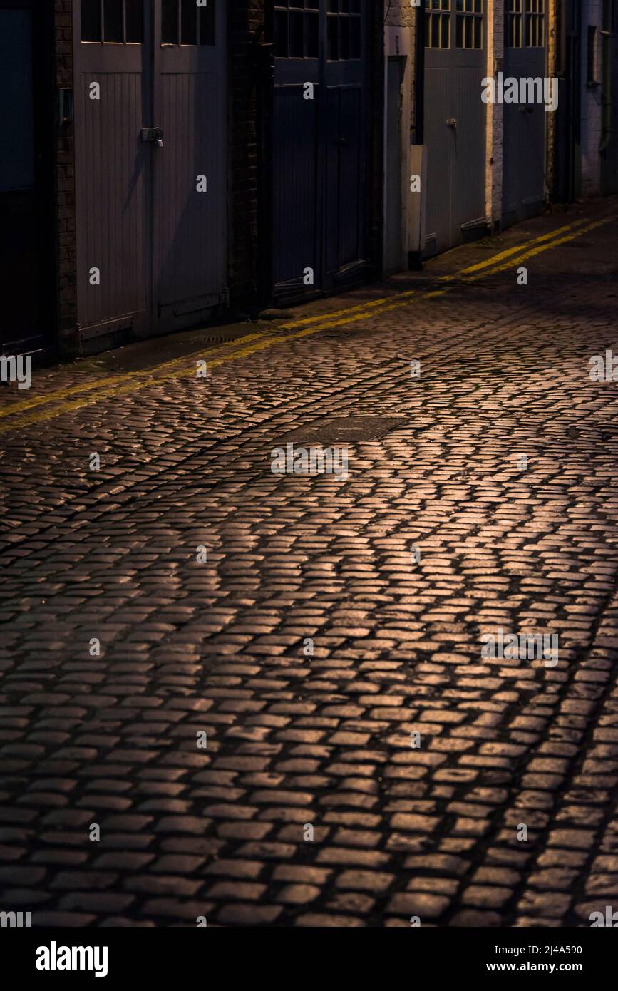 Cobblestone street at night, London, England, UK Stock Photo - Alamy
