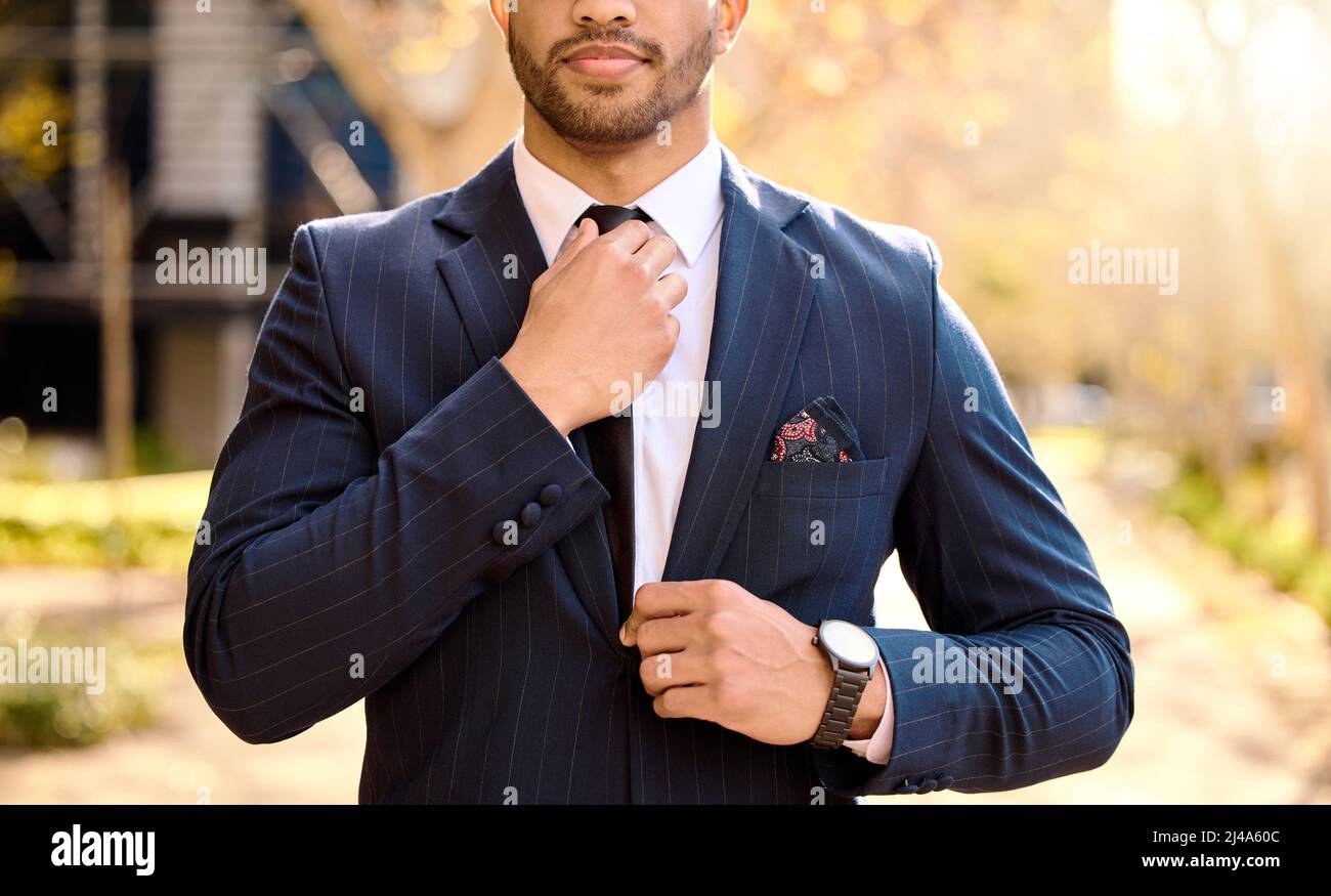 A sharp suit makes a good impression. Shot of a businessman adjusting ...