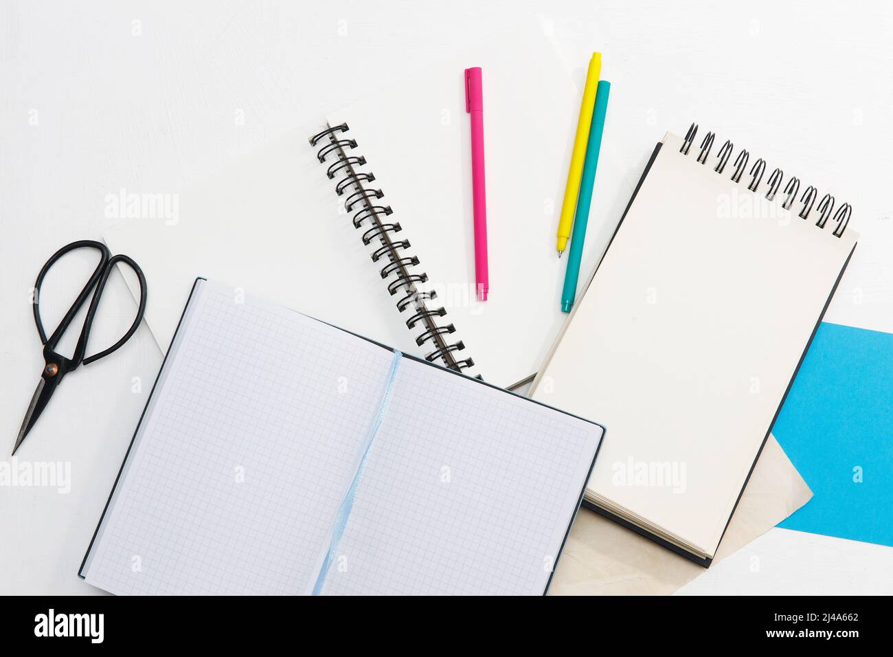 A lot of notebooks on springs, multi-colored paper: blue, red, green ...