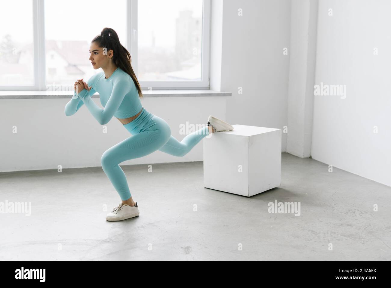 Female athlete doing box step ups at the gym, copy space Stock Photo ...