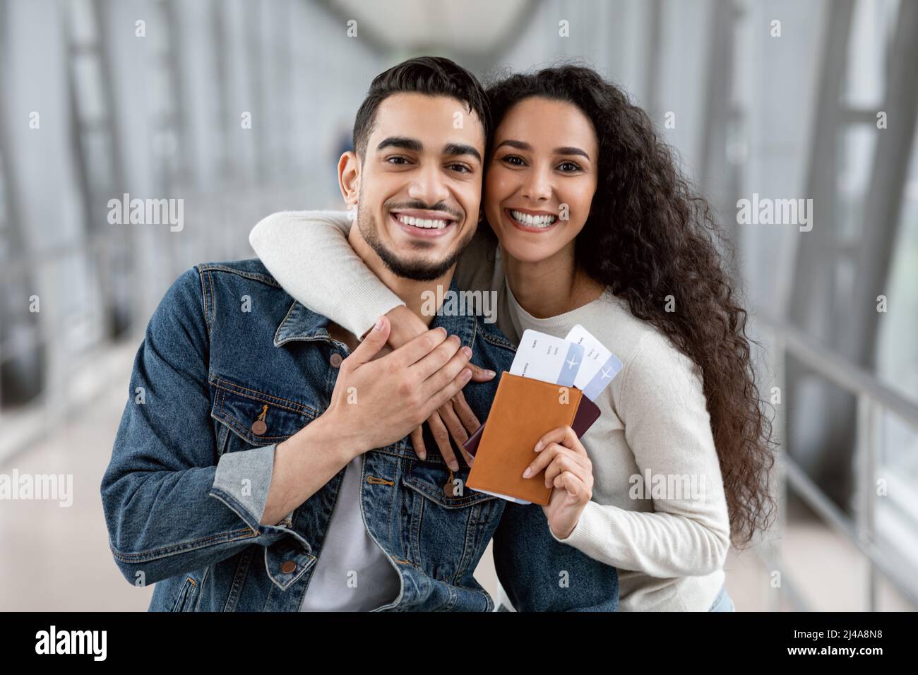 Joyful Millennial Arab Spouses With Passports And Tickets In Hands At ...
