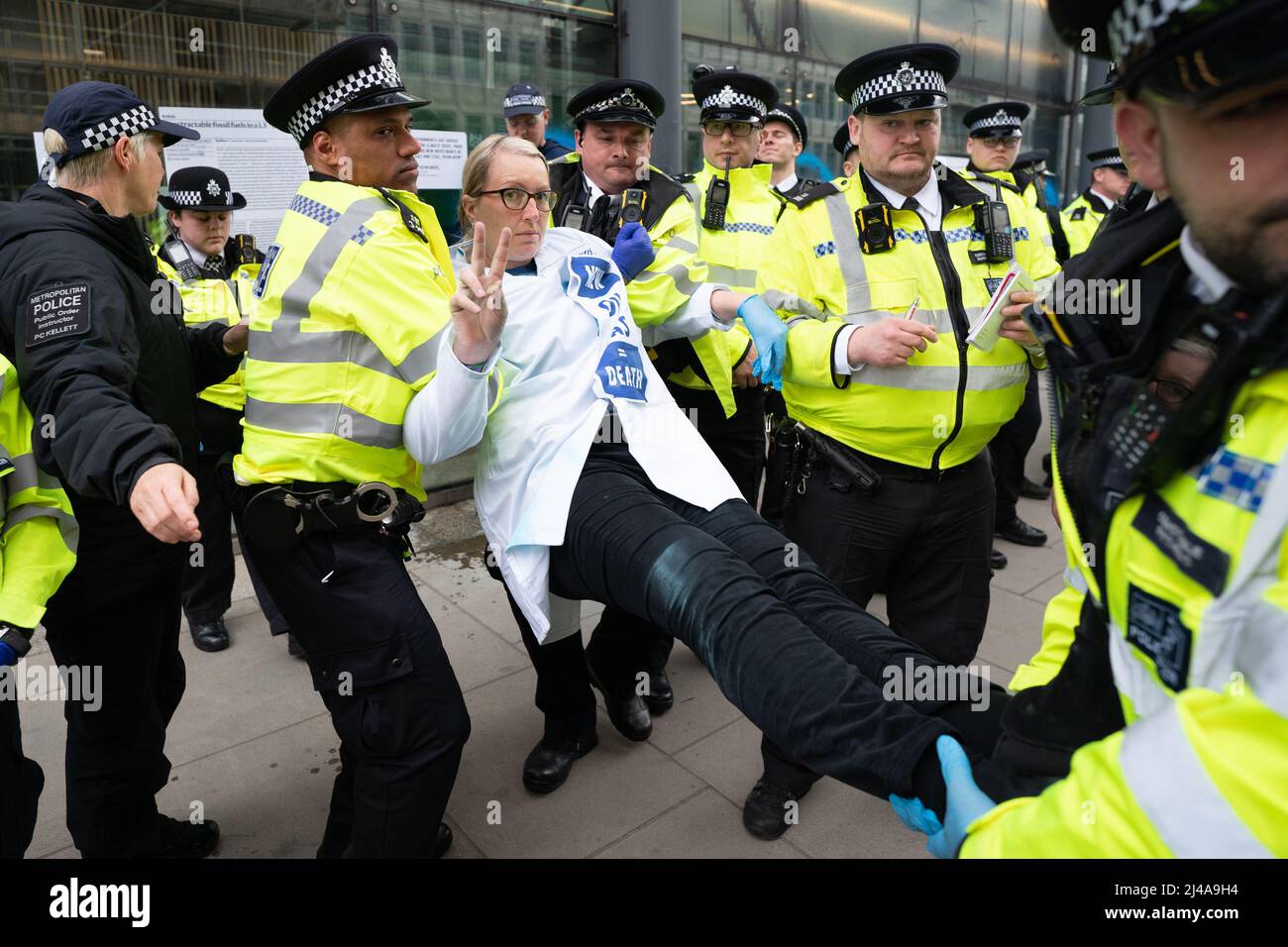 A demonstrator is carried away by police outside the Department for ...