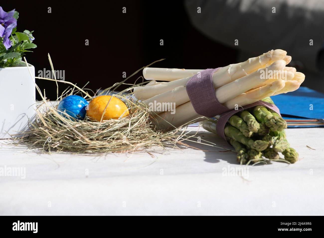 Table decoration made of asparagus and Easter eggs in the colors of ...